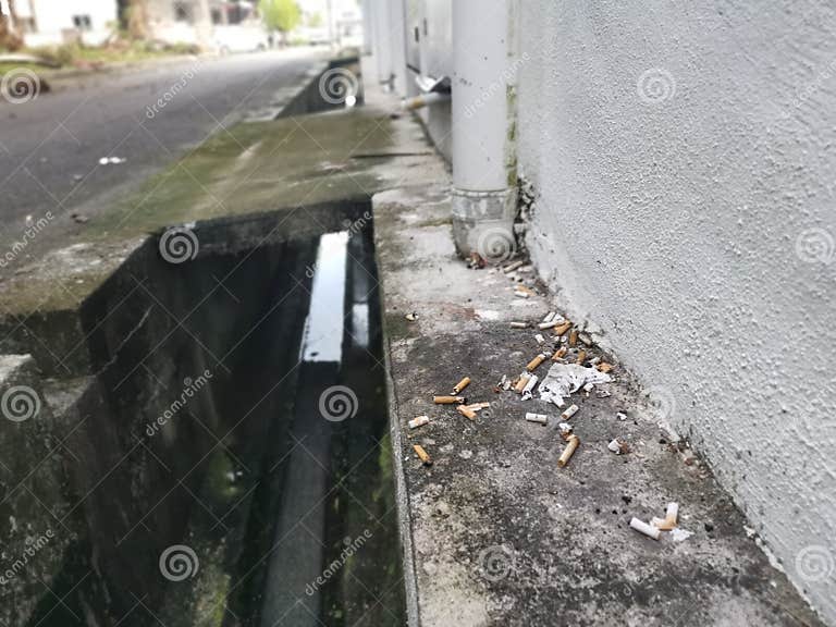 Leftover Cigarette Butts by the Corner of the Dirty Drain. Stock Photo ...