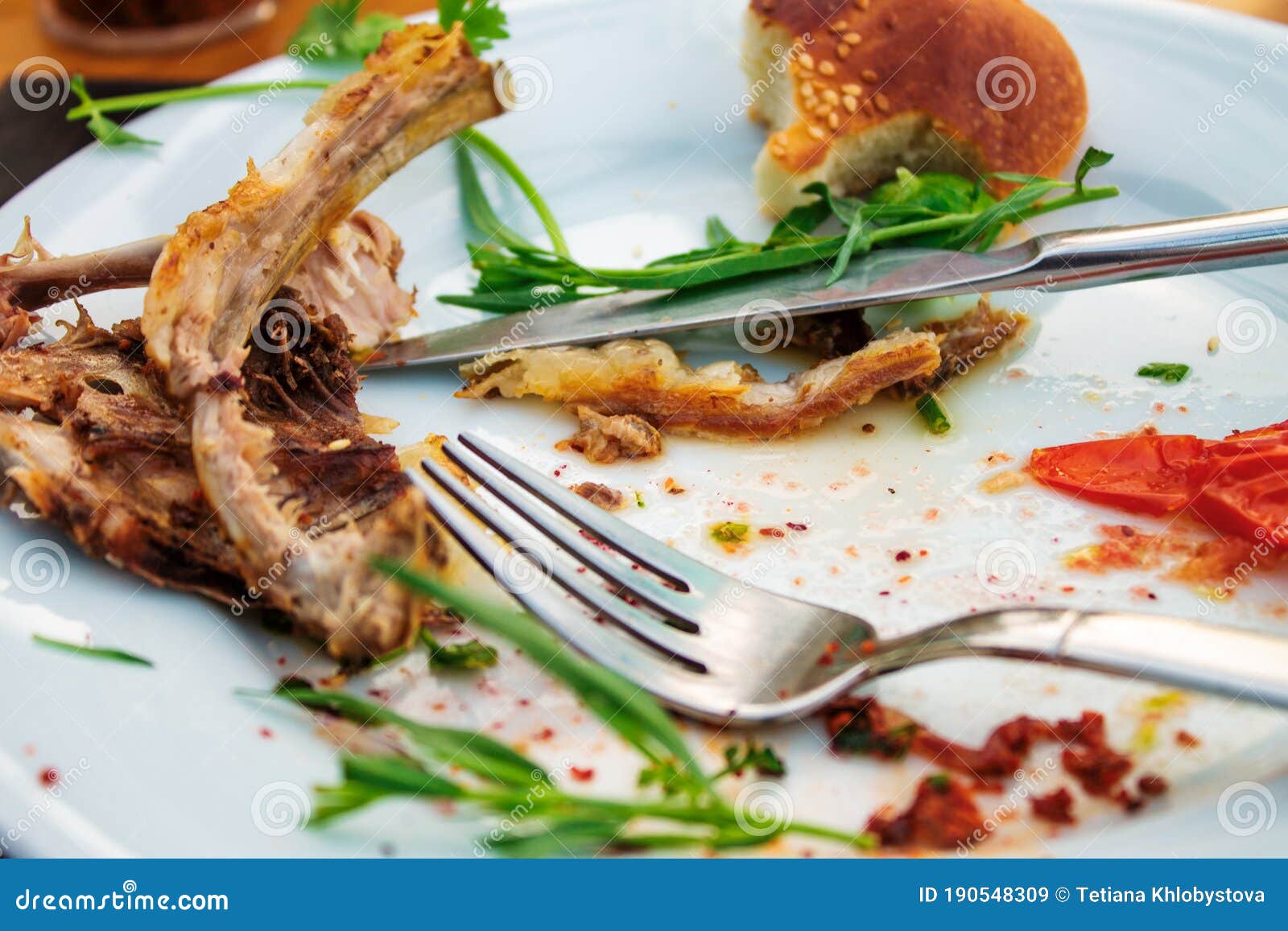 Leftovers and Cutlery in Plate on Table Stock Image - Image of ...
