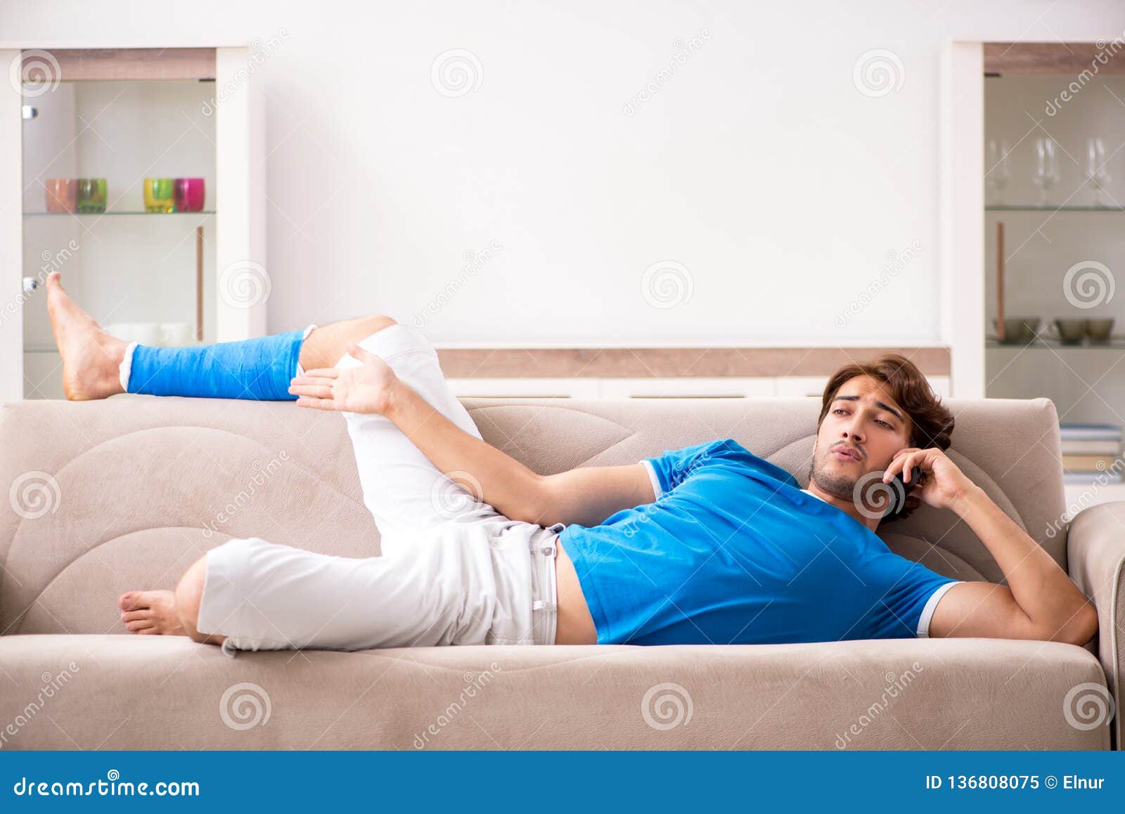 The Leg Injured Young Man on the Sofa Stock Image - Image of accident ...