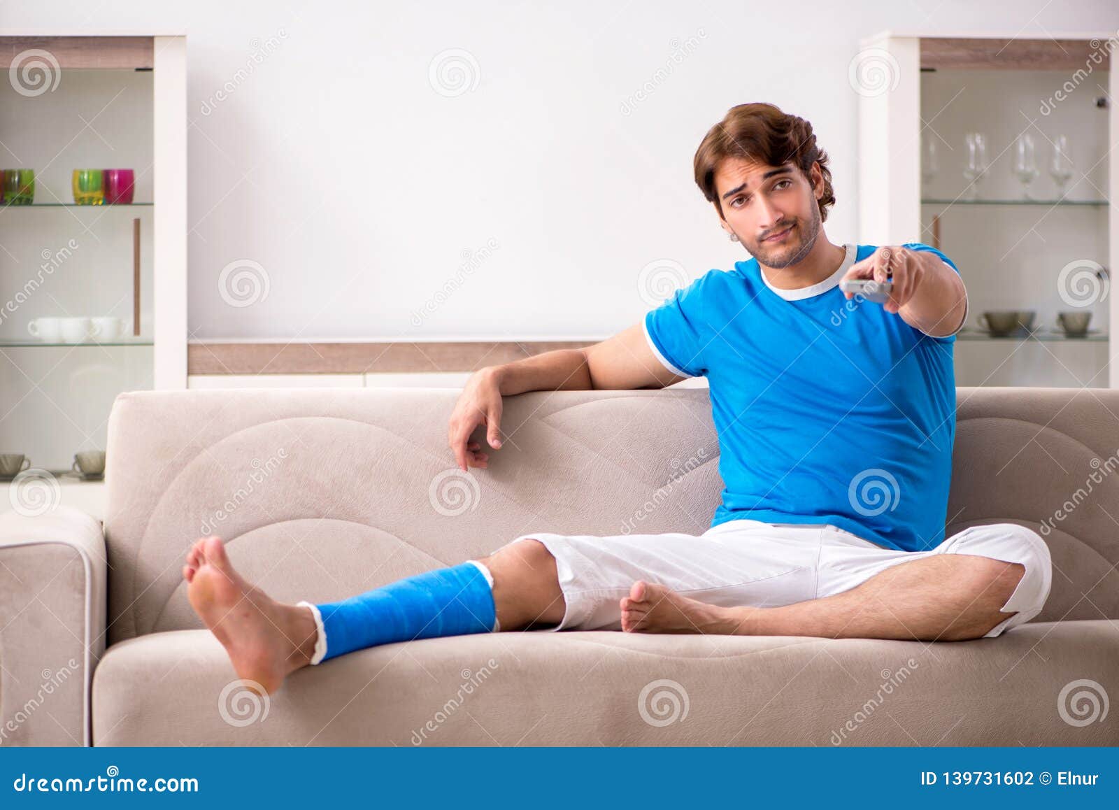 The Leg Injured Young Man on the Sofa Stock Photo - Image of bandaged ...
