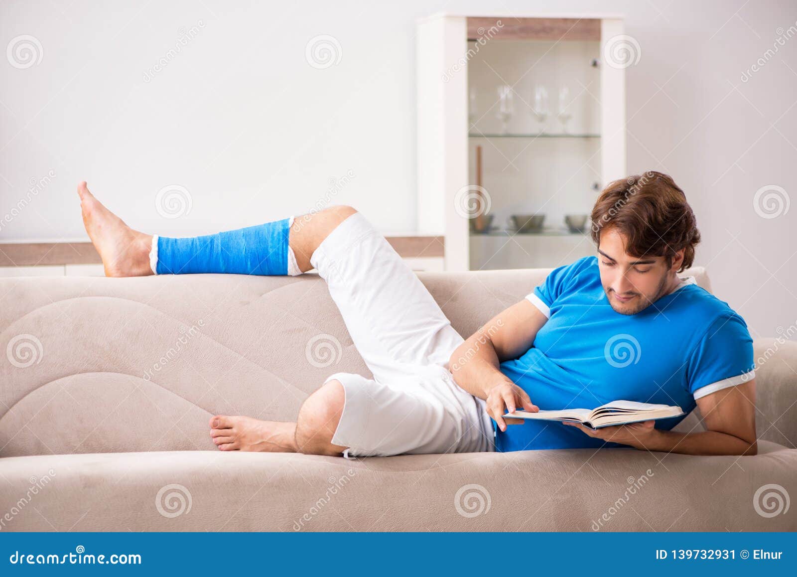 The Leg Injured Young Man on the Sofa Stock Image - Image of bandaged ...