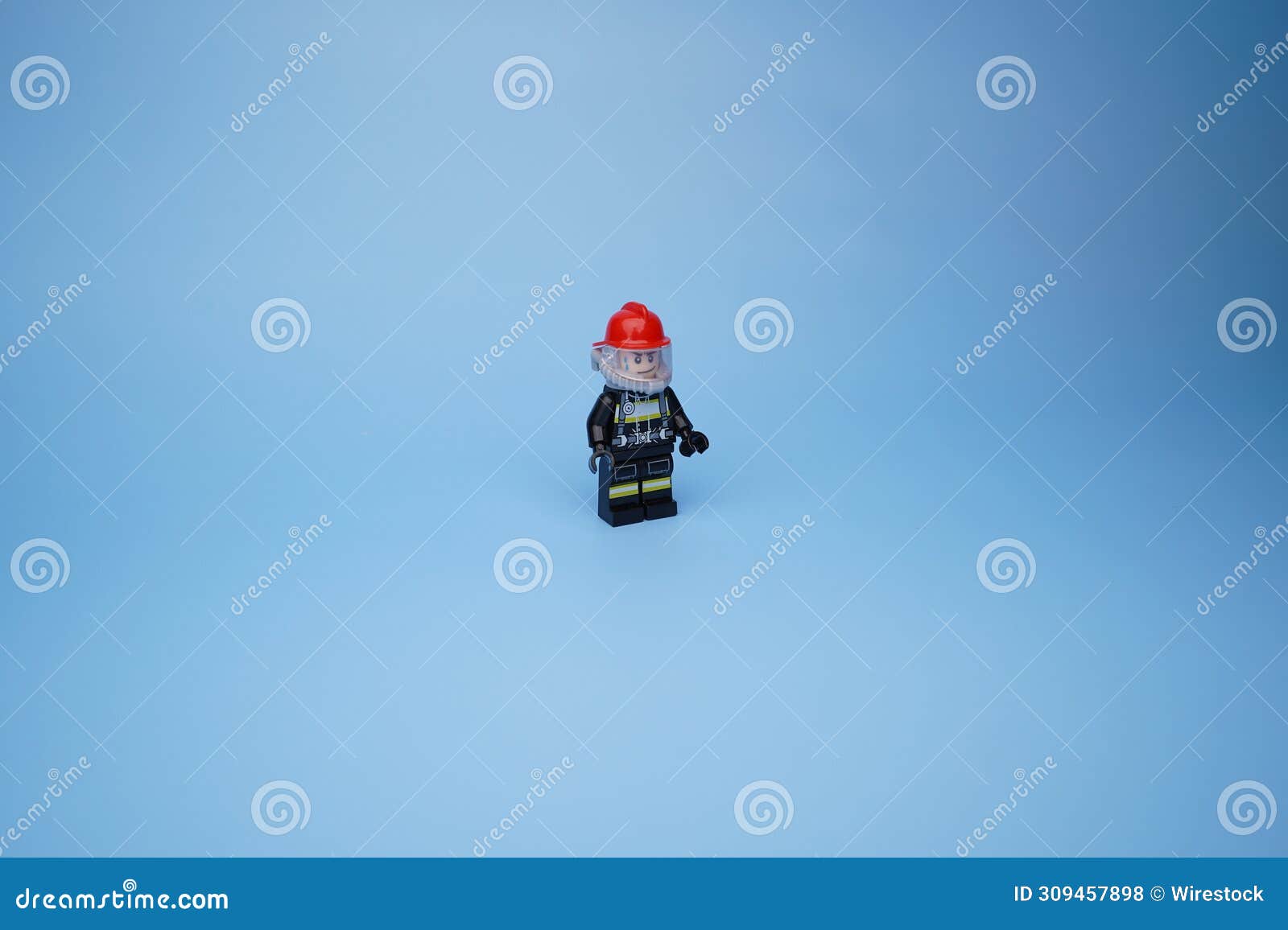 Lego Firefighter Isolated Against an Empty Blue Background Editorial ...