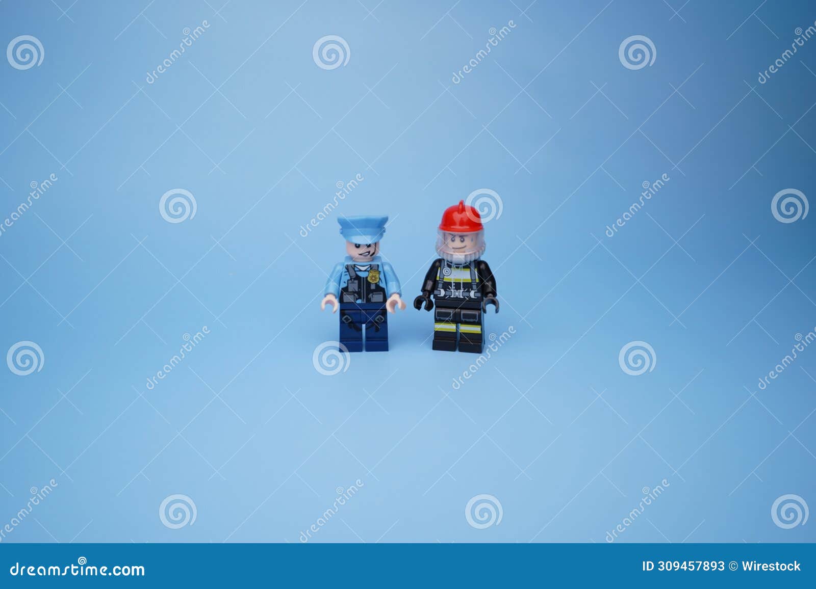 Lego Policeman and a Firefighter Isolated Against an Empty Blue ...
