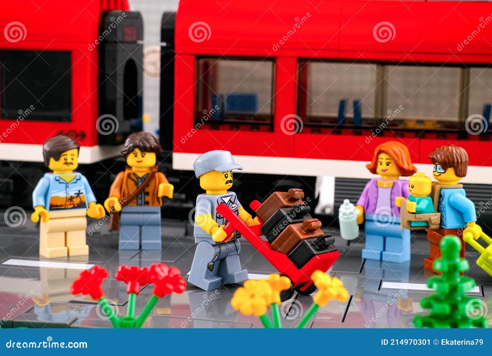 Lego Porter with Stack of Suitcases and Some Passengers on the Platform ...