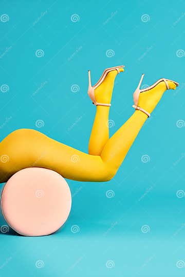 Legs Of Beautiful Young Woman Wearing Bright Yellow Tights And High