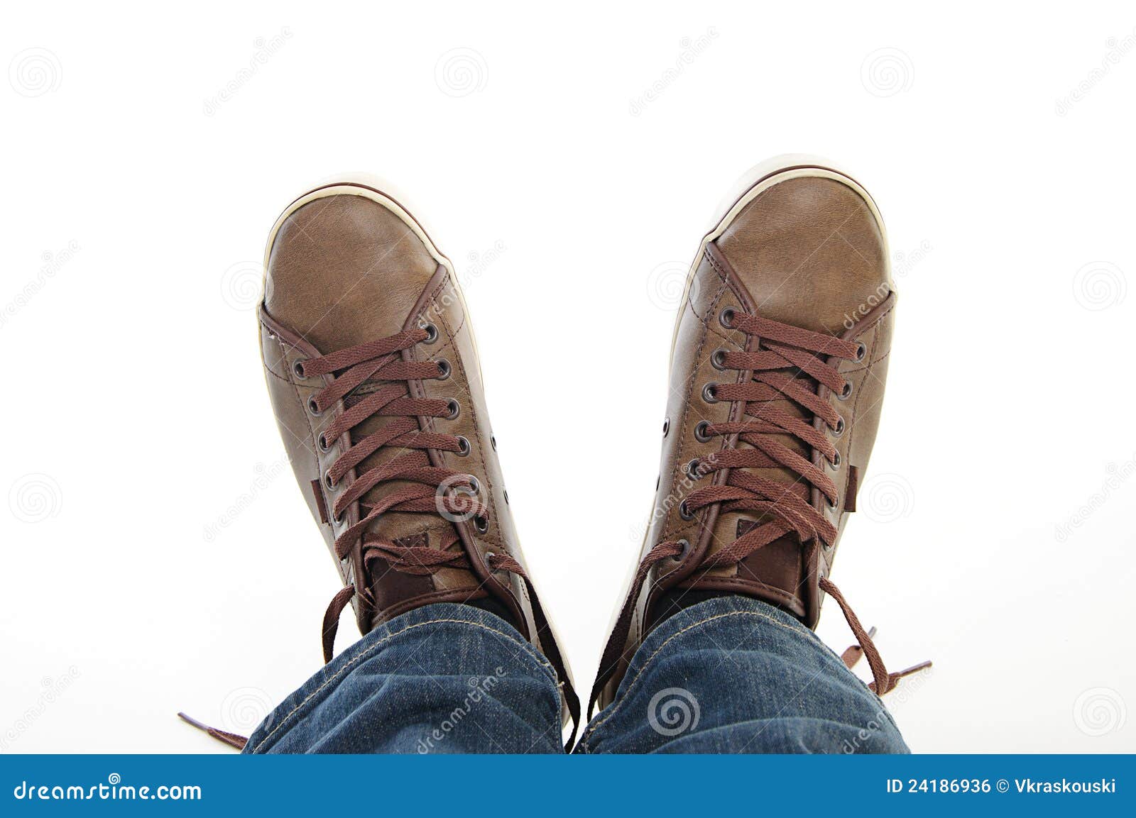 Legs in Brown Shoes Sneakers and Jeans Lying Stock Photo - Image of ...