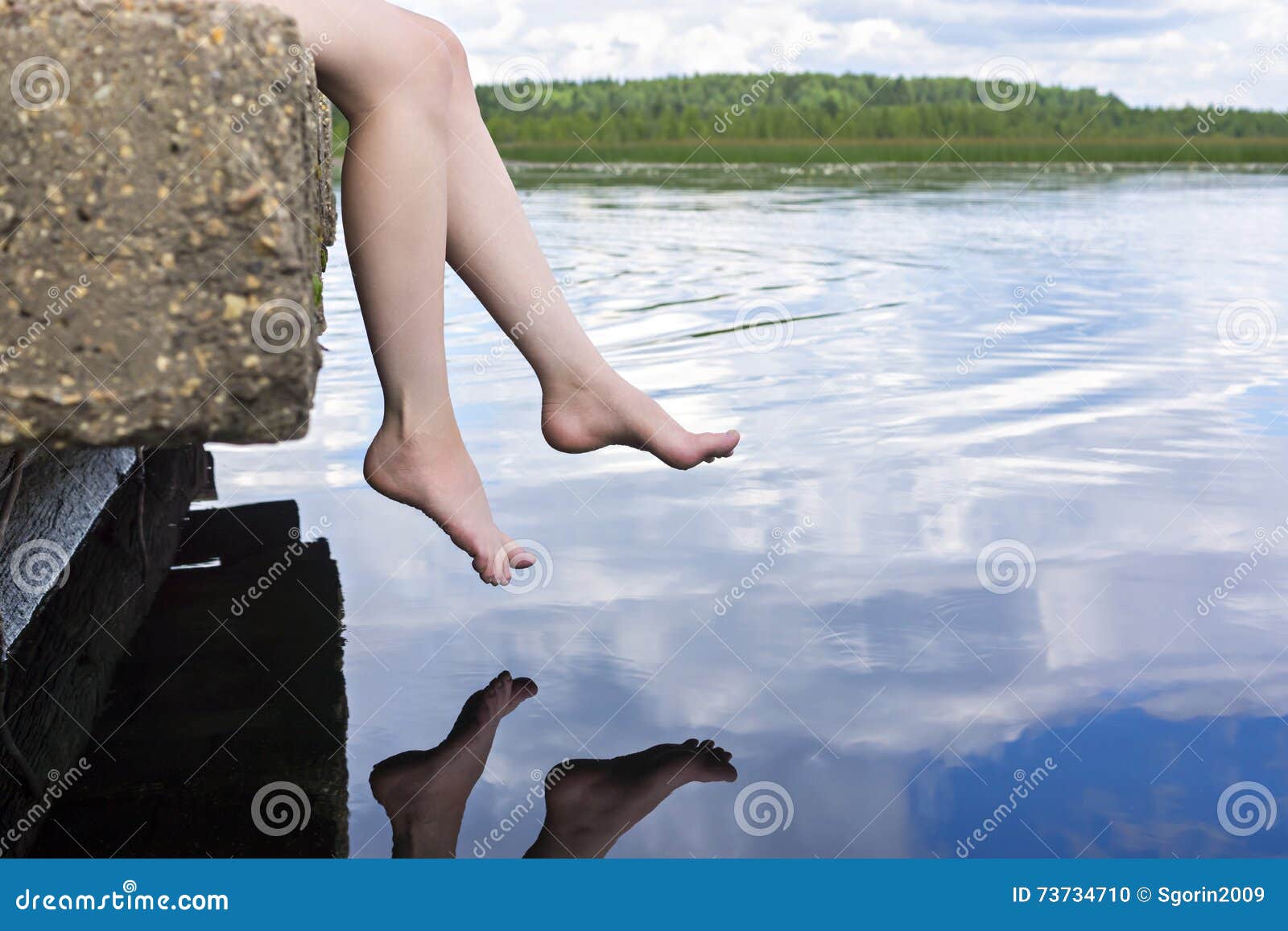 Legs dangling over water stock photo. Image of background - 73734710