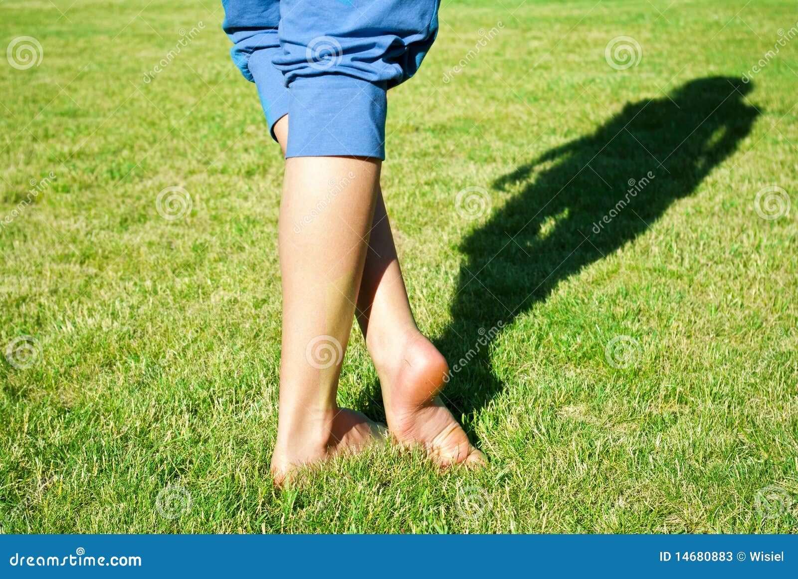 Legs on grass with shadow stock image. Image of body - 14680883