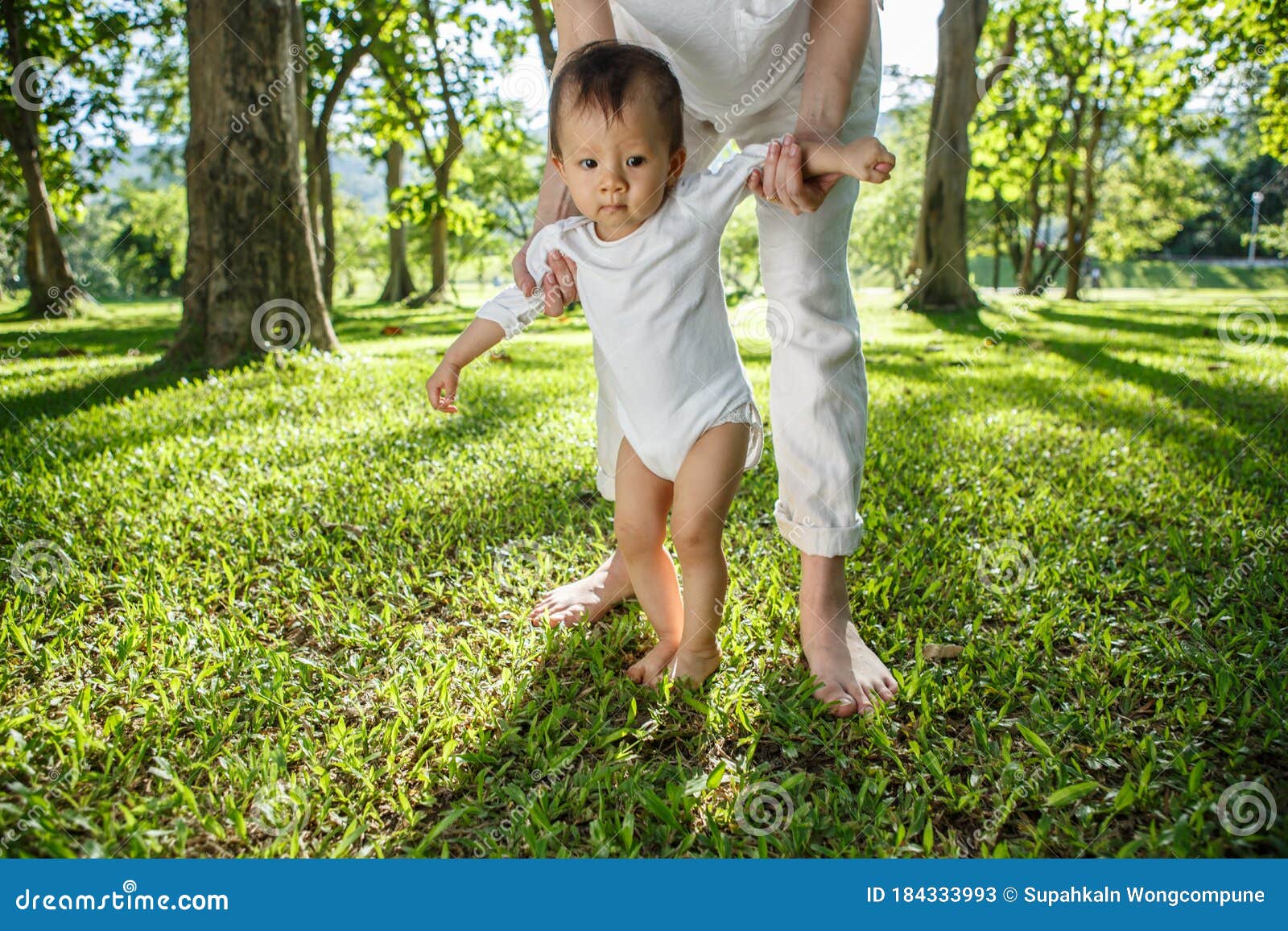Baby`s First Steps. Small And Large Feet Close-up. Teach Your Child To ...