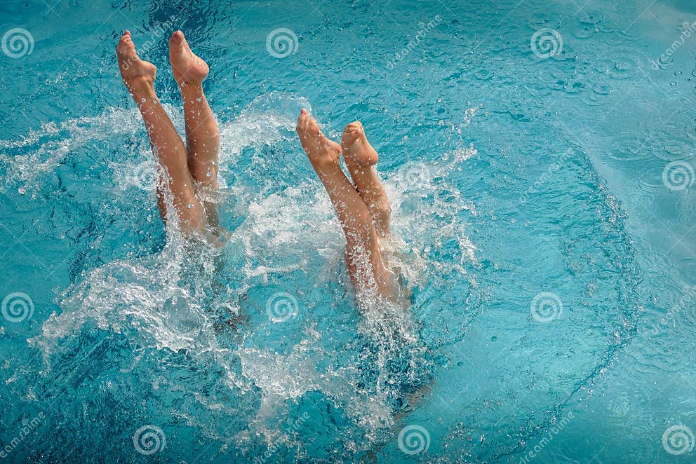 Legs of Synchronized Swimmers Girls Peeking Out of the Pool Water in a ... Legs of Synchronized Swimmers Girls Peeking Out of the Pool Water in a ...