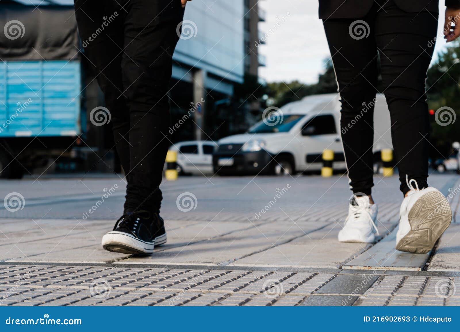 Legs of Two Men Walking Along the Sidewalk Calmly. Front View Stock ...