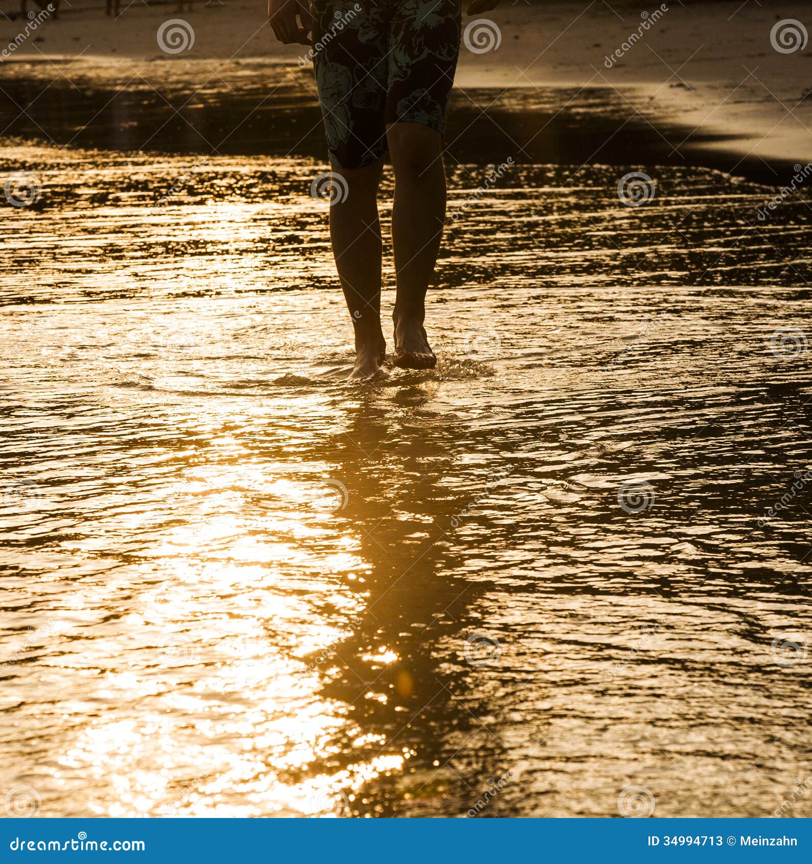 Legs of Walking Man in the Water at the Beach in Backlight Stock Image ...