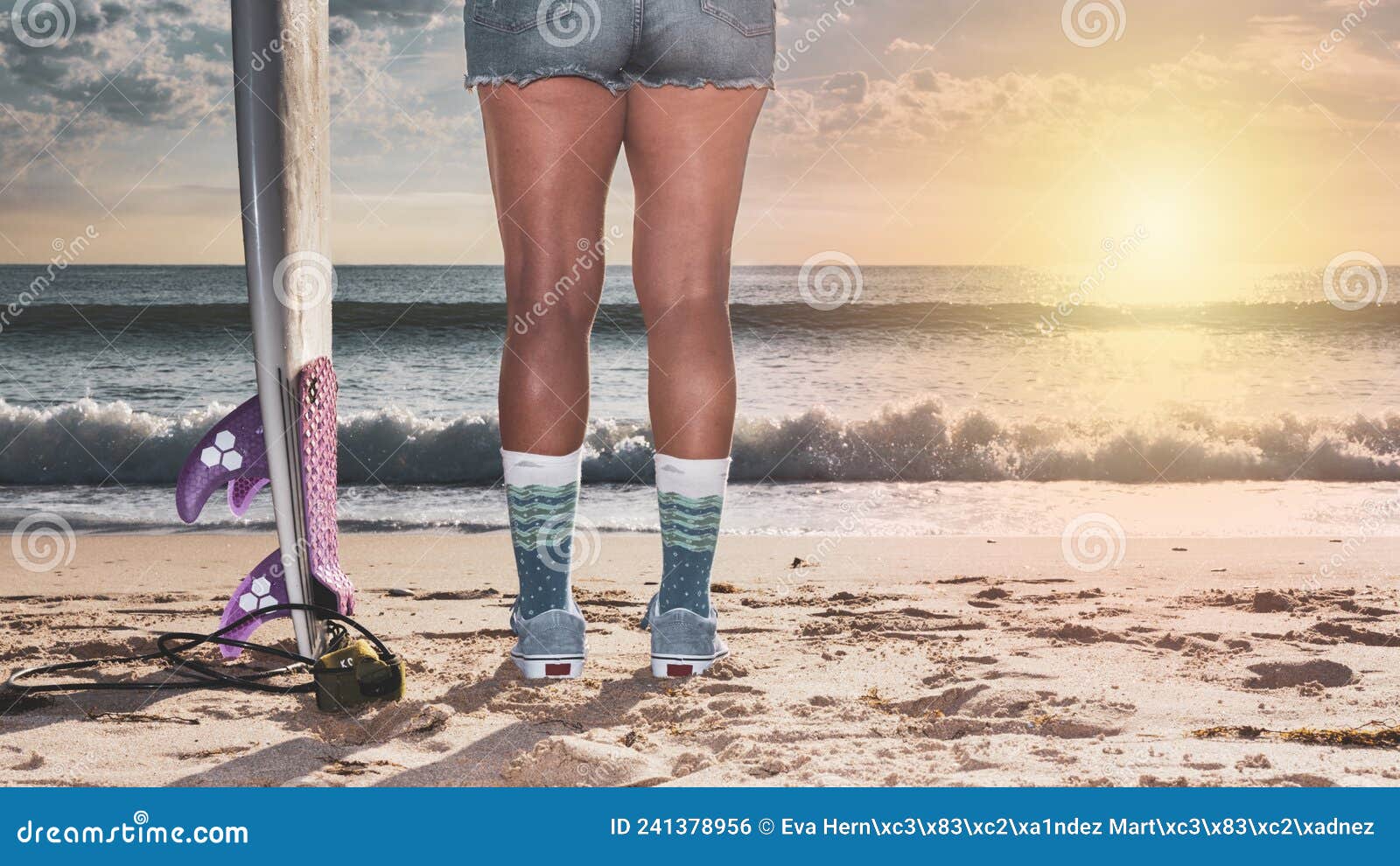 Legs of Woman Dressed in Surf Clothes in Front of Beach with Surfboard ...