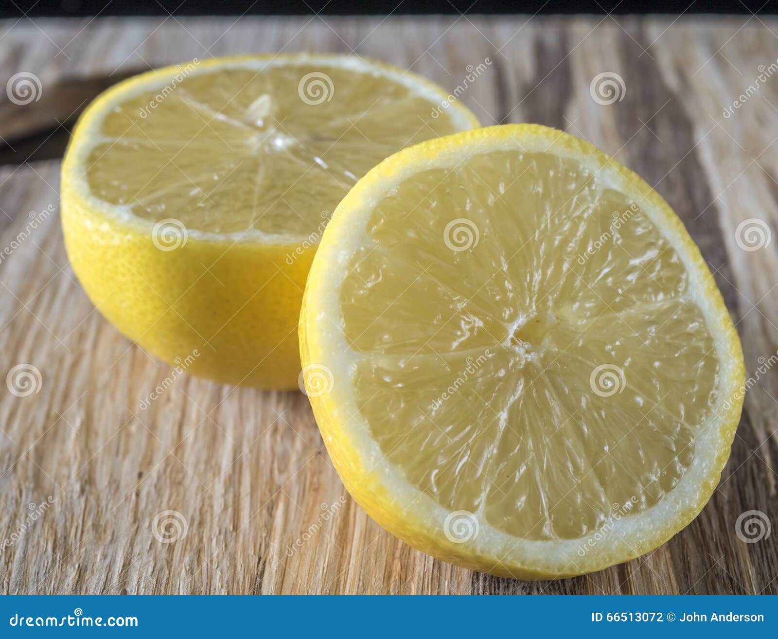 Lemon cut in half stock photo. Image of seeds, board - 66513072