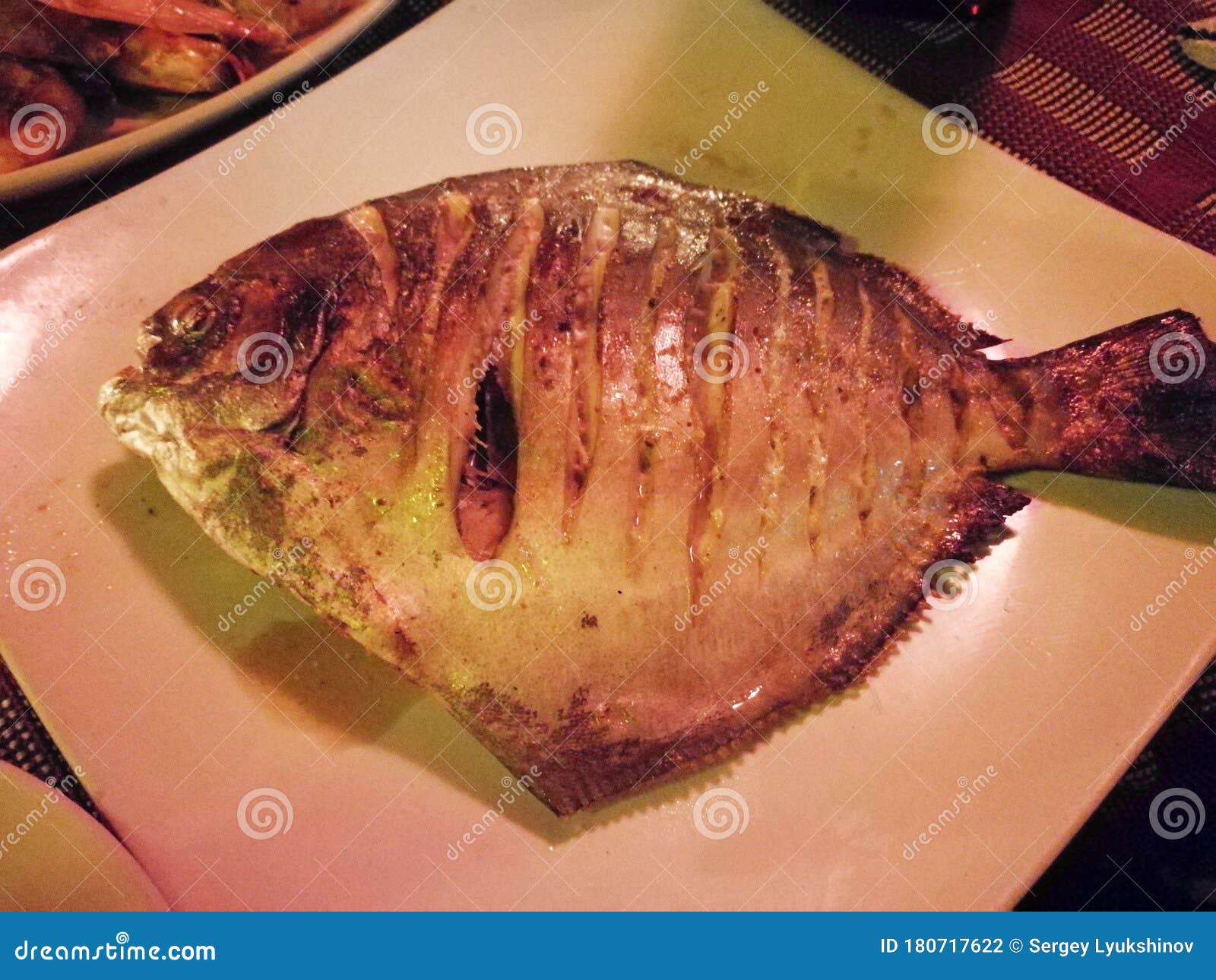 Lemon Fish Whole Grilled on a Restaran Plate Stock Photo - Image of ...