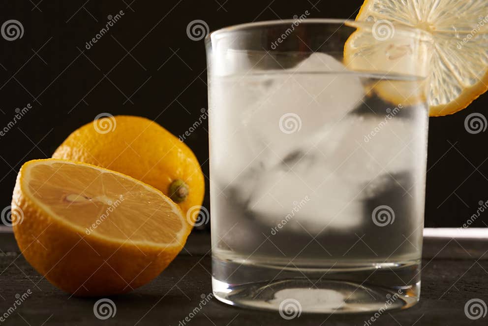 Lemon and a Glass of Ice Water Stock Photo - Image of fresh, texture ...