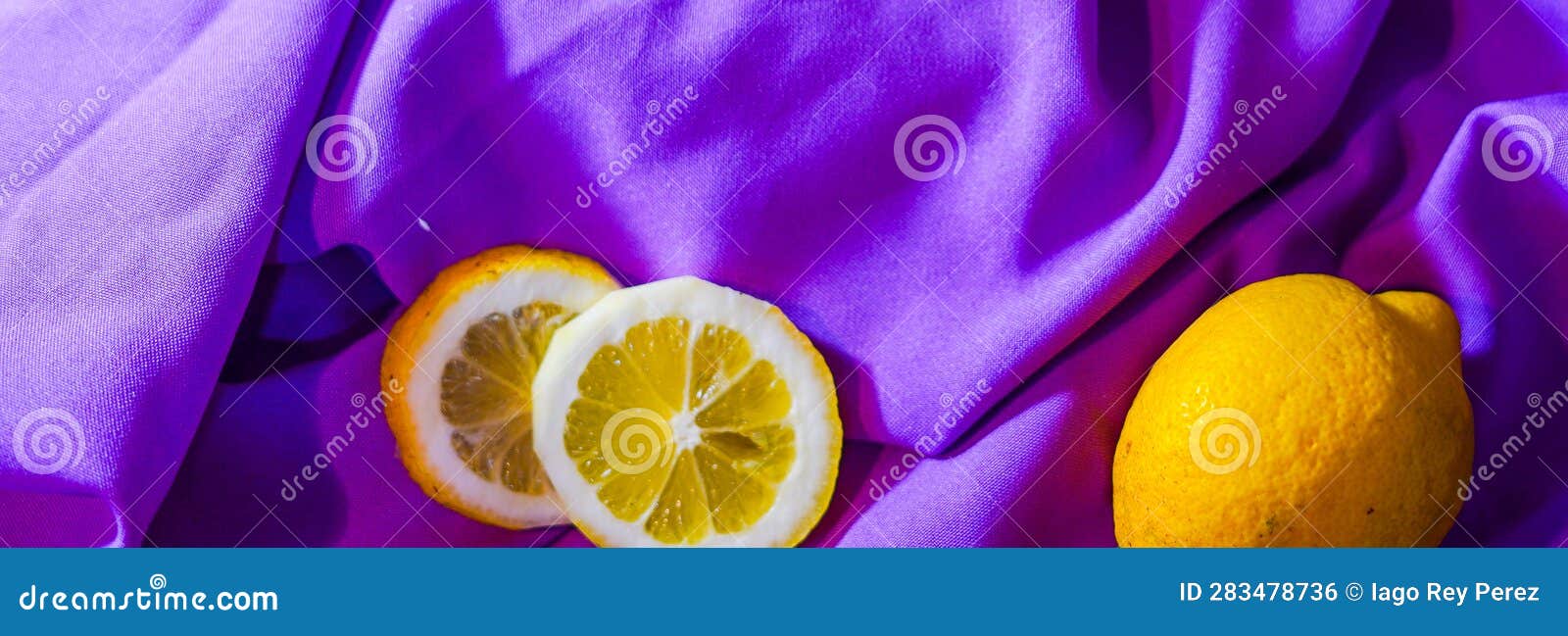 A lemon on a purple cloth stock photo. Image of creative - 283478736