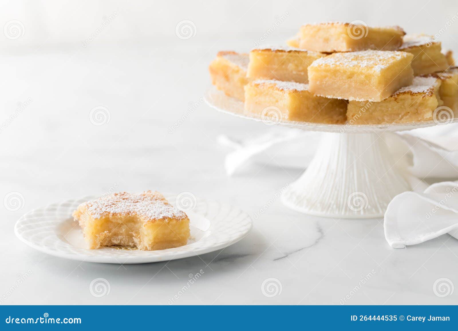 A Lemon Square with a Bite Out in Front of a Stand Full of Lemon ...