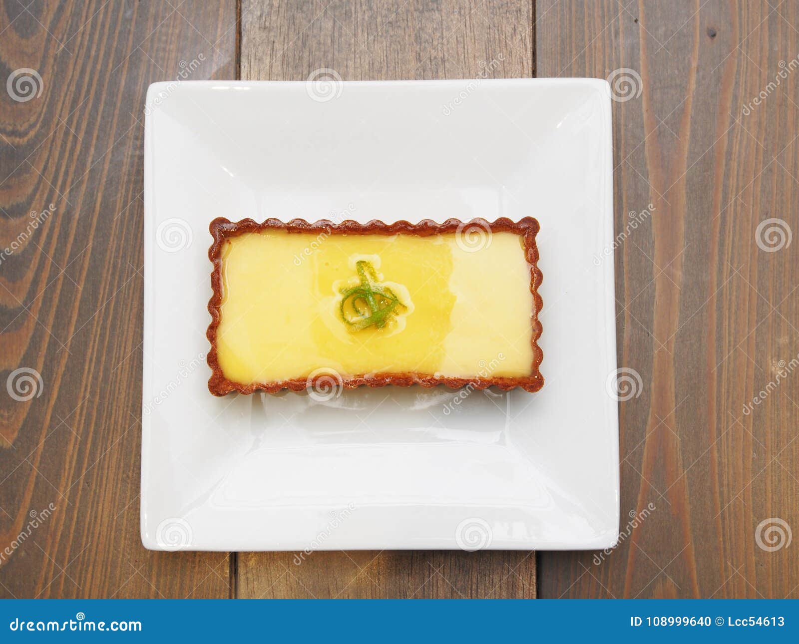 Lemon tart on a plate stock photo. Image of bakery, plate - 108999640