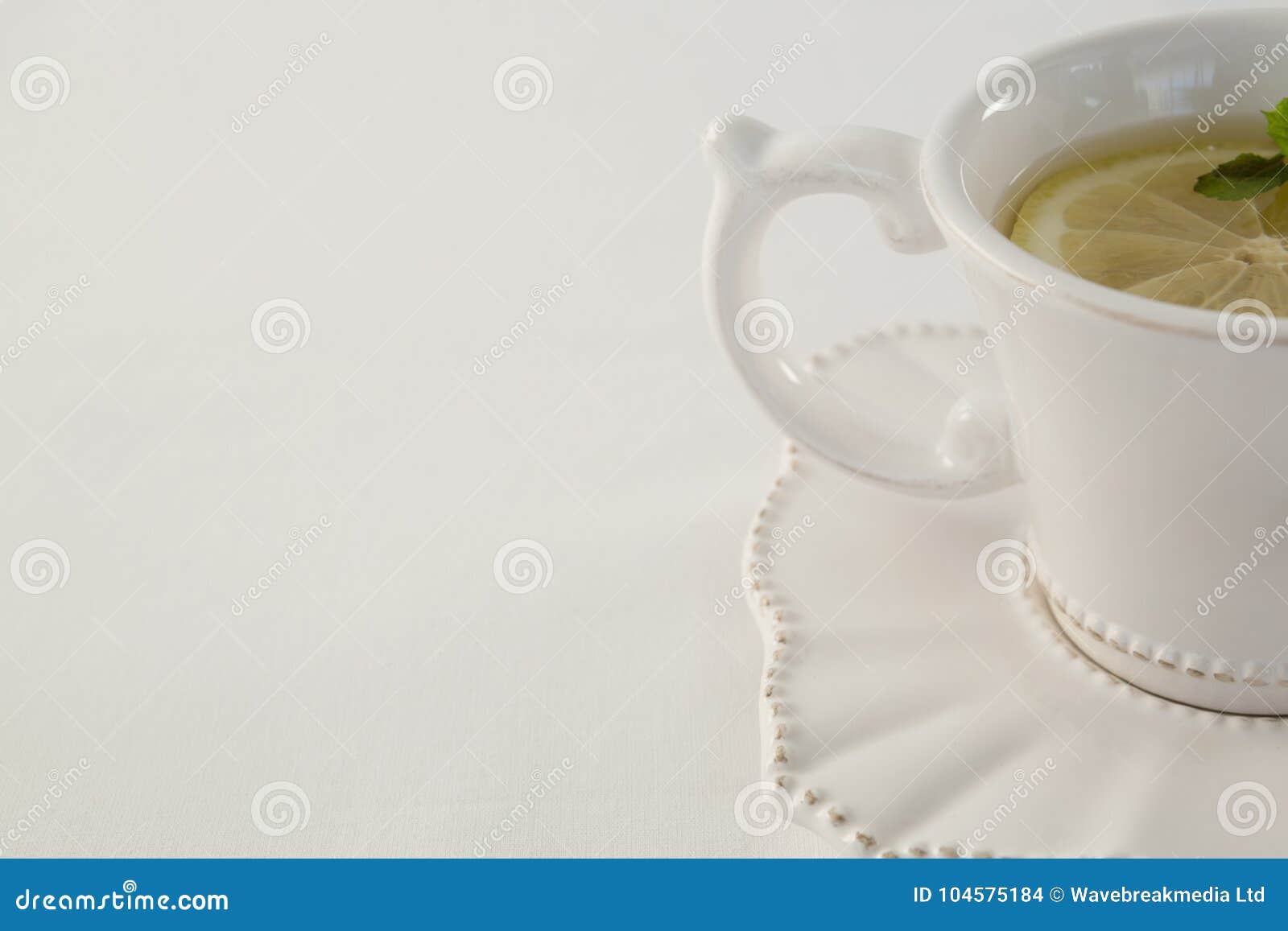 Lemon tea in a cup stock photo. Image of studio, drink - 104575184