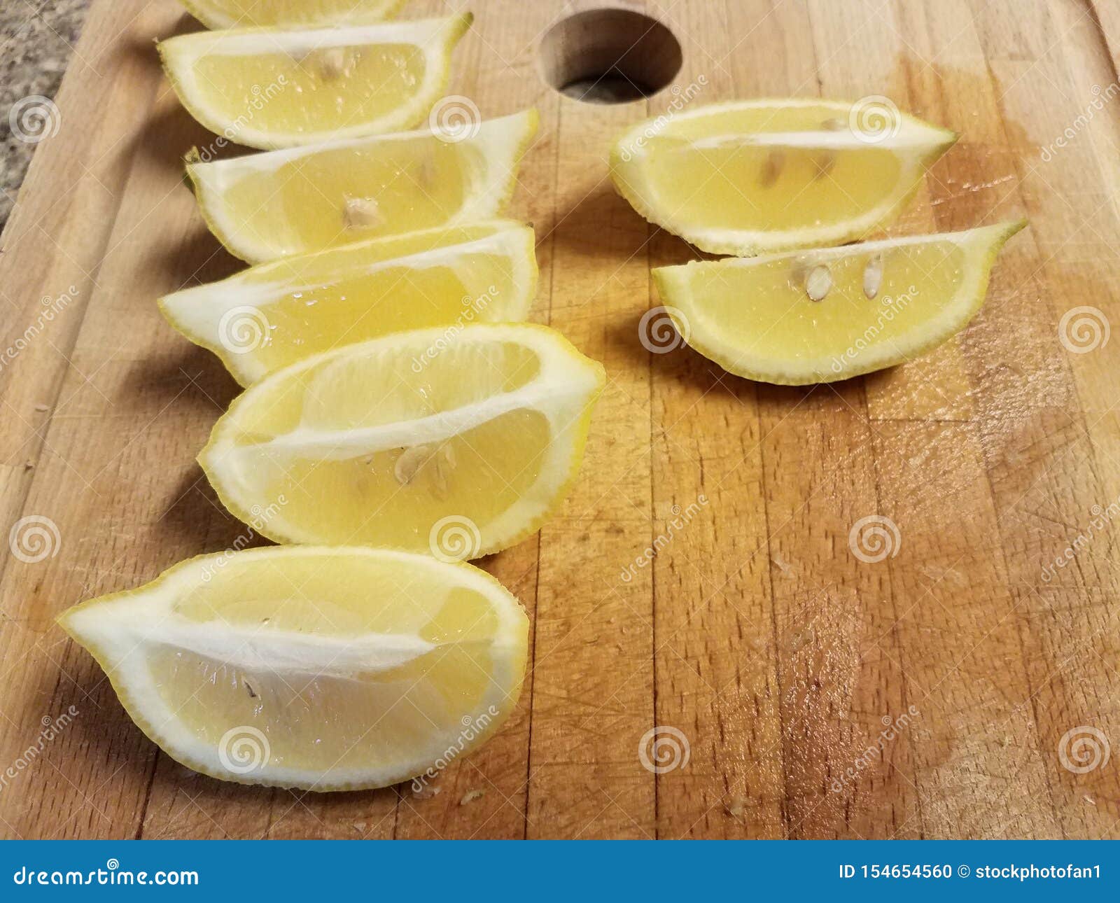 Lemon Wedges or Slices on Wet Cutting Board Stock Photo - Image of ...