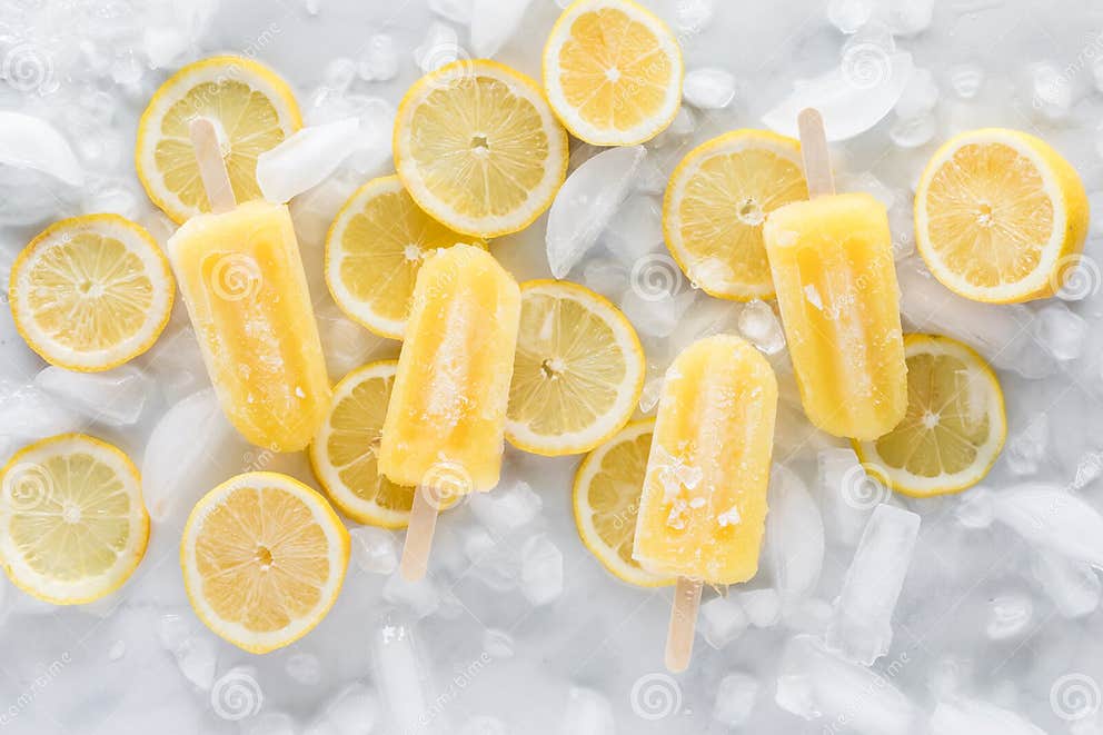Lemonade Ice Pops on a Bed of Lemon Slices with Ice Cubes. Stock Photo ...