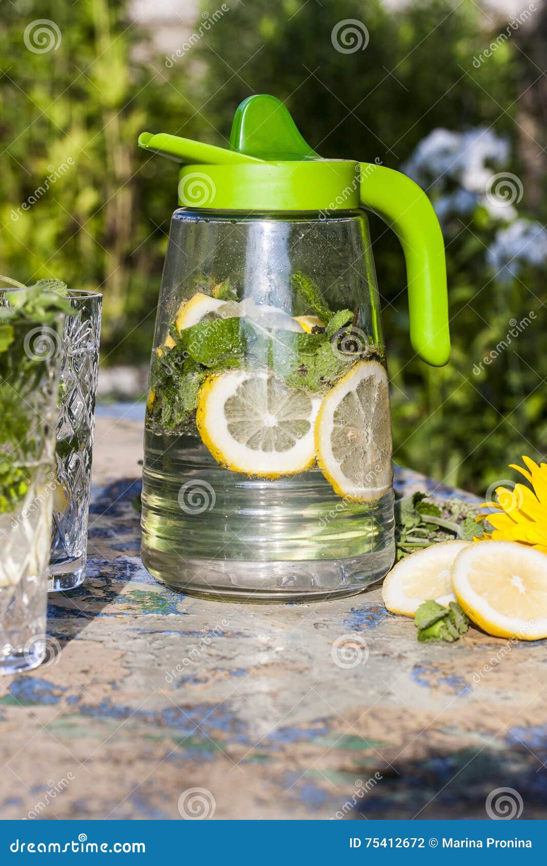Lemonade Pitcher with Lemon and Mint on Garden Table Stock Photo ...