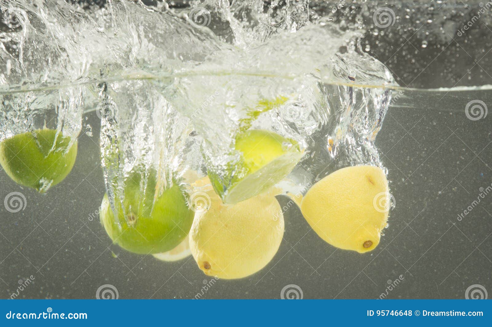 Lemons and Limes Making a Splash Stock Photo - Image of clear, water ...