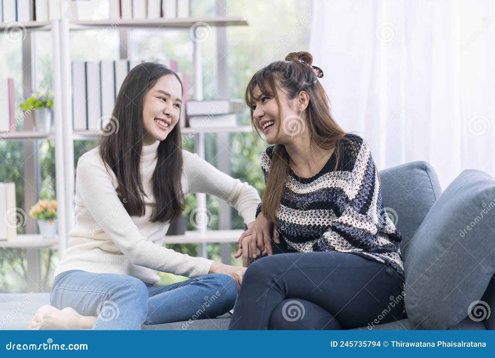 Lesbian Couple Laughing In The Living Room At Home Young Caucasian