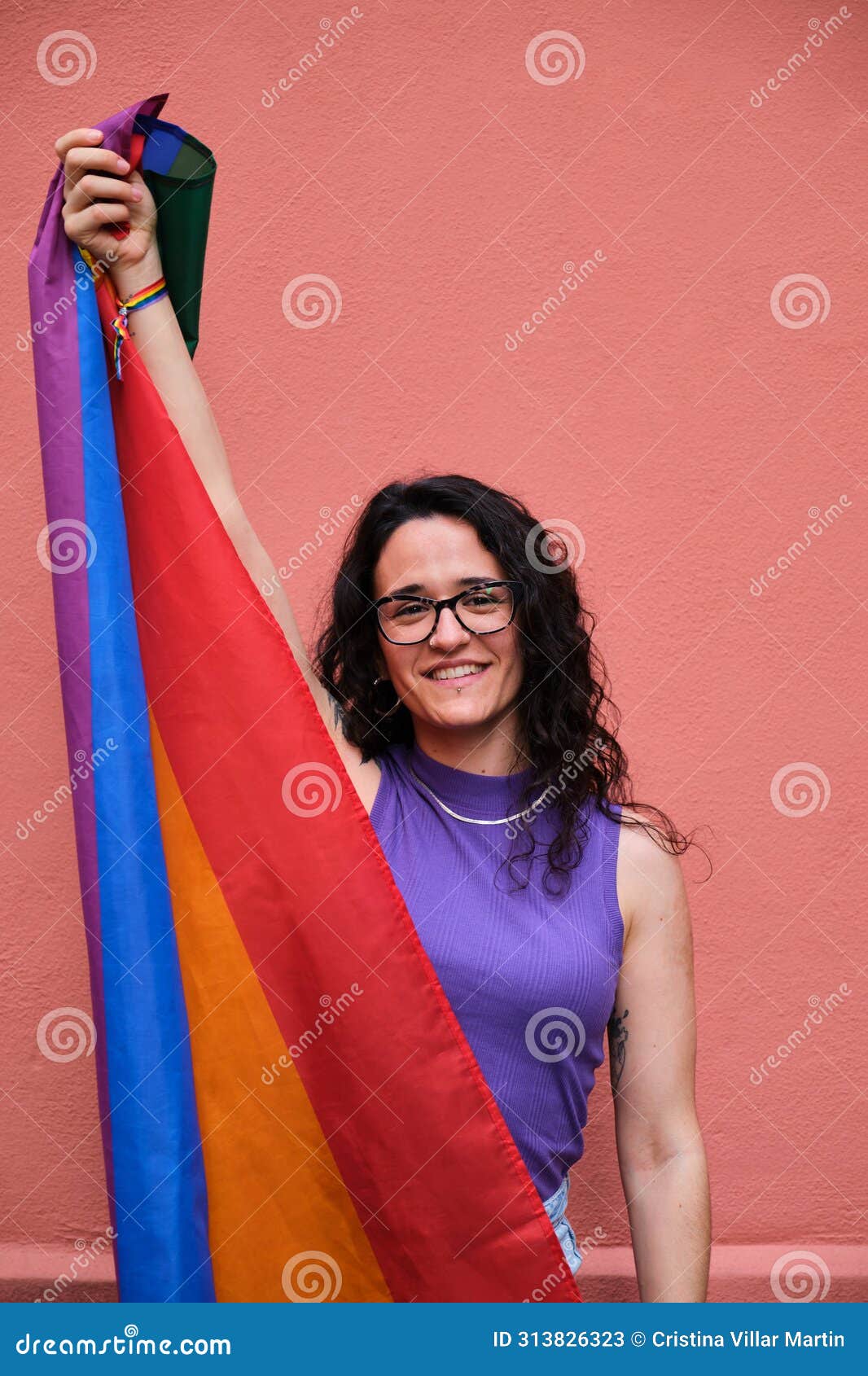 Lesbian Woman Is Holding A Rainbow Flag And Smiling Celebrating Pride