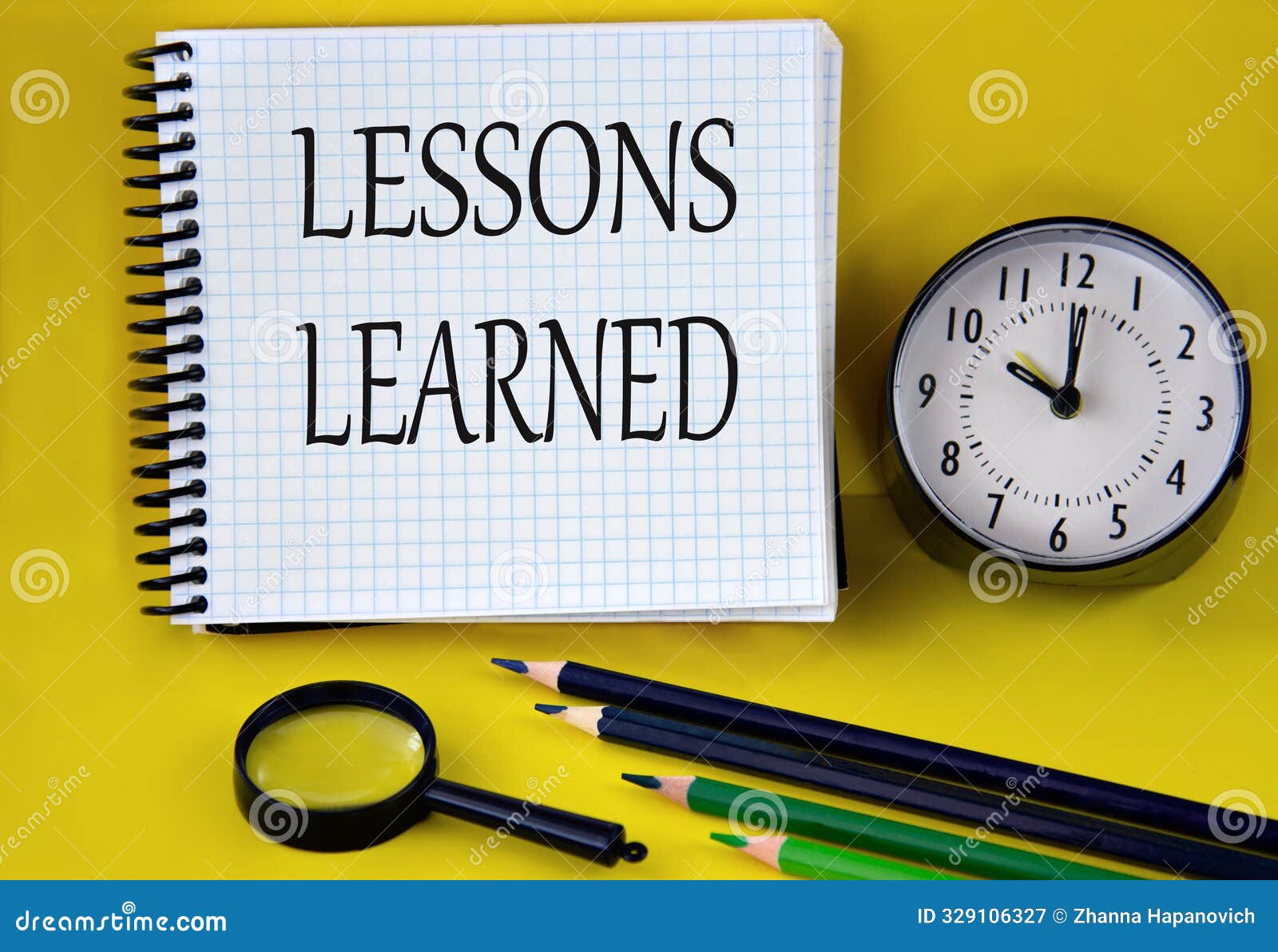 LESSONS LEARNED - Words in a White Notebook with an Alarm Clock ...