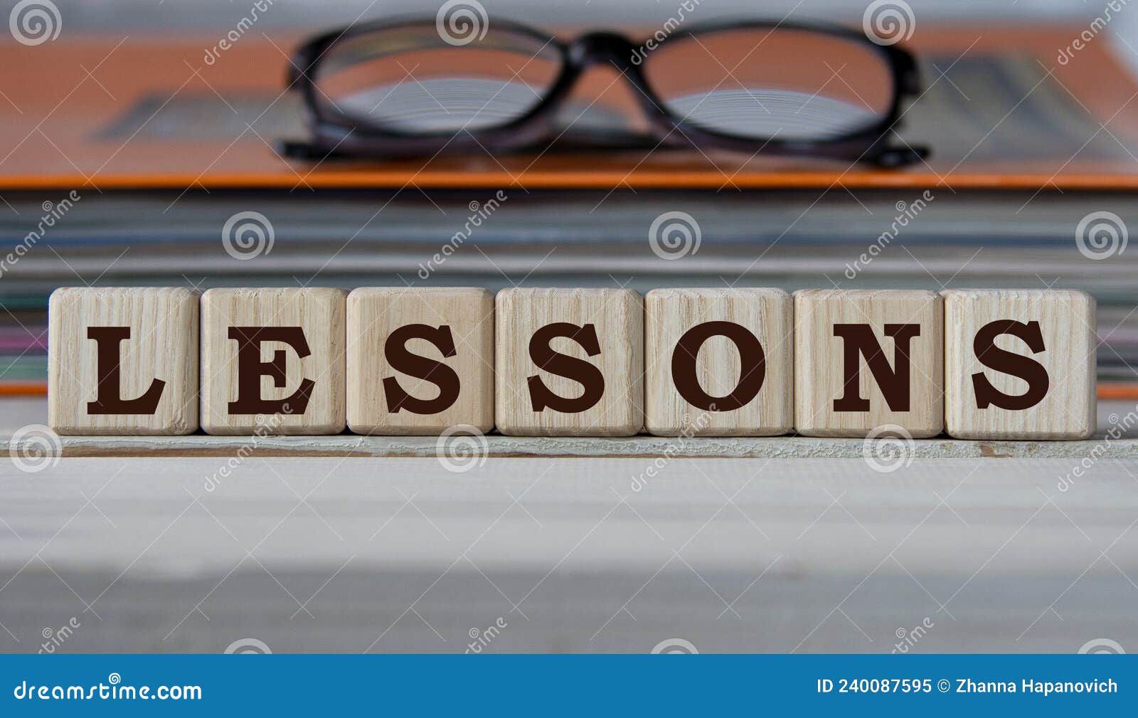 LESSONS - Word on Wooden Cubes on the Background of a Folder with ...