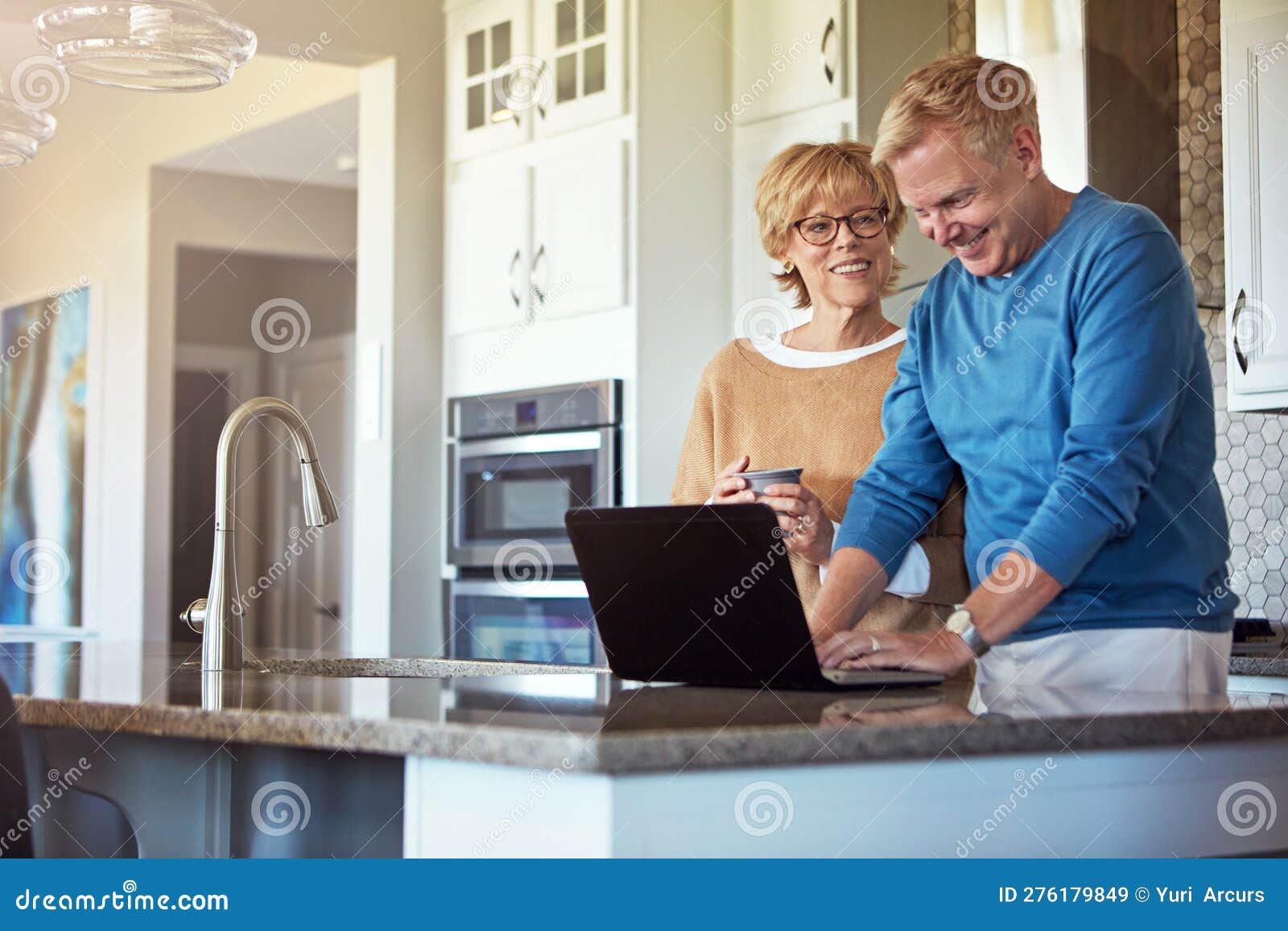 Let Me Just Log in...a Mature Couple Using Their Laptop in the Kitchen ...