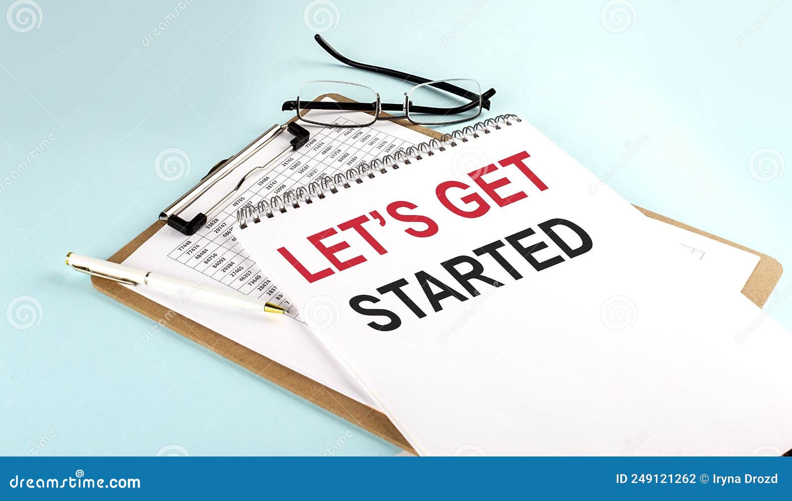 LET`S GET STARTED Text on Notepad on Clipboard with Chart on Blue ...