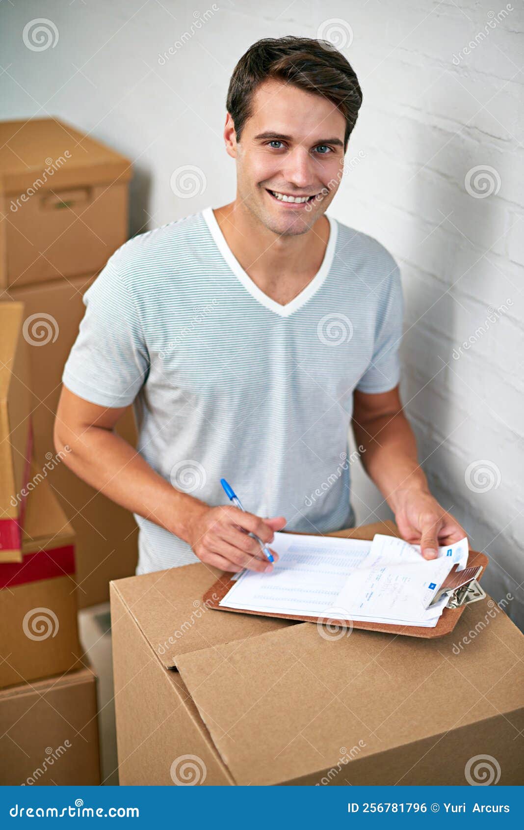 Let the Unpacking Begin. a Young Man Signing a Document for the ...