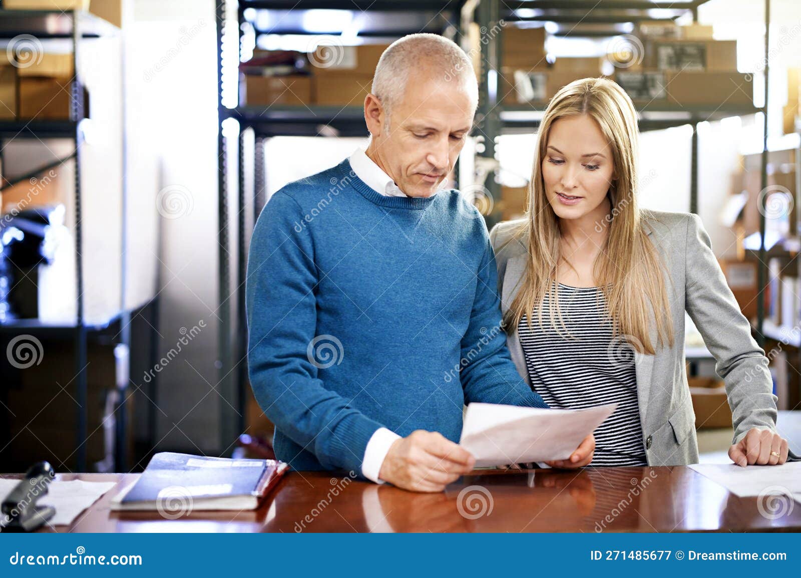 Lets Check the Status of this Order. a Two Managers Looking through ...