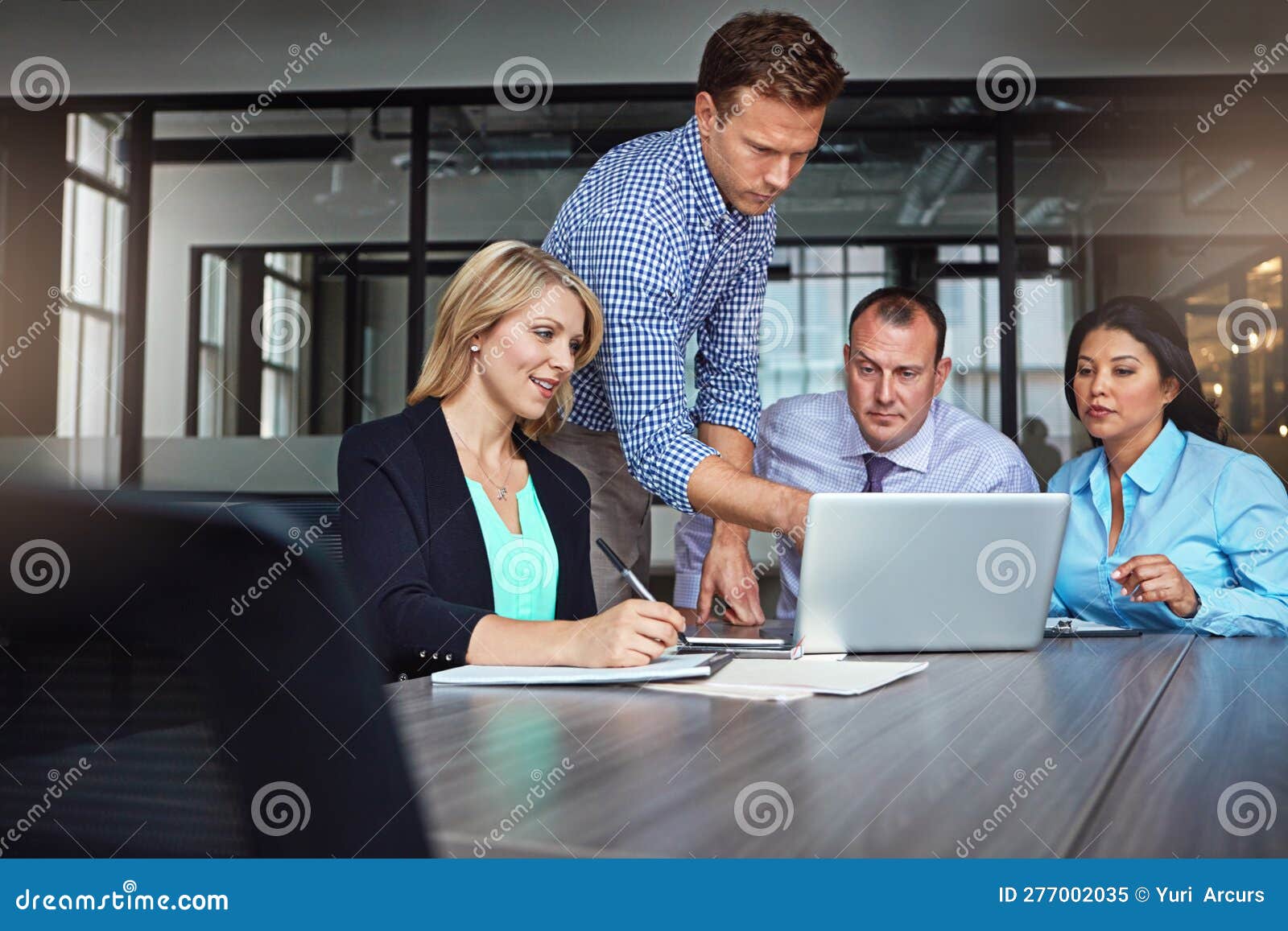 Lets Explore this a Bit More. a Group of Colleagues Using a Laptop ...