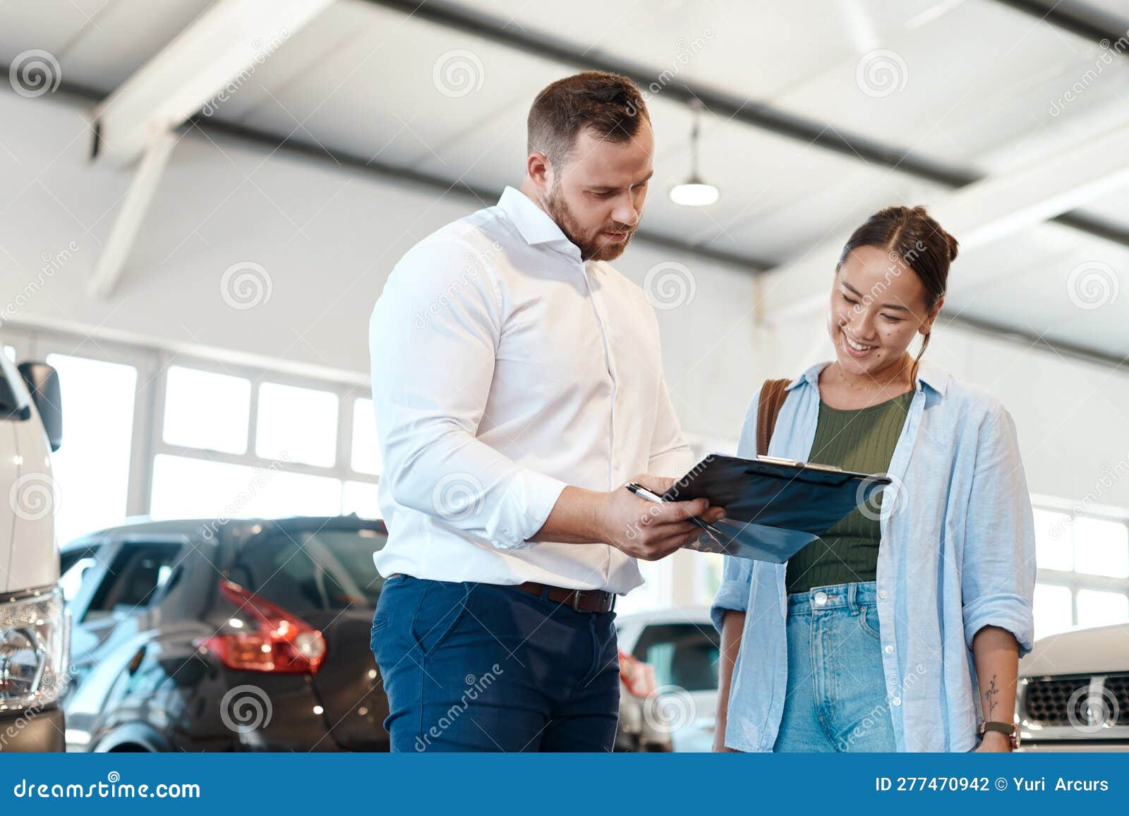 Lets Get these Contracts Signed. a Car Salesman Going Over Paperwork ...