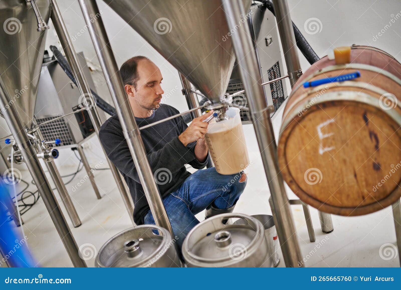 Lets Give this Batch a Test. a Man Working in a Microbrewery. Stock ...