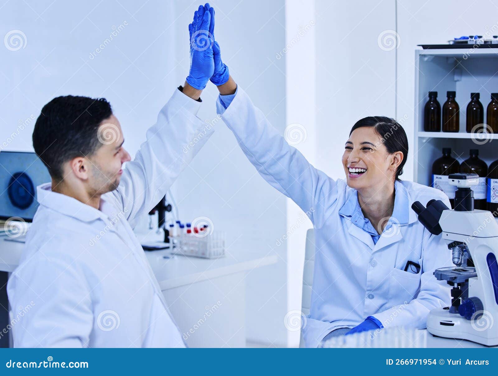 Lets Go. Two Young Scientists High Fiving while Working in Their Lab ...