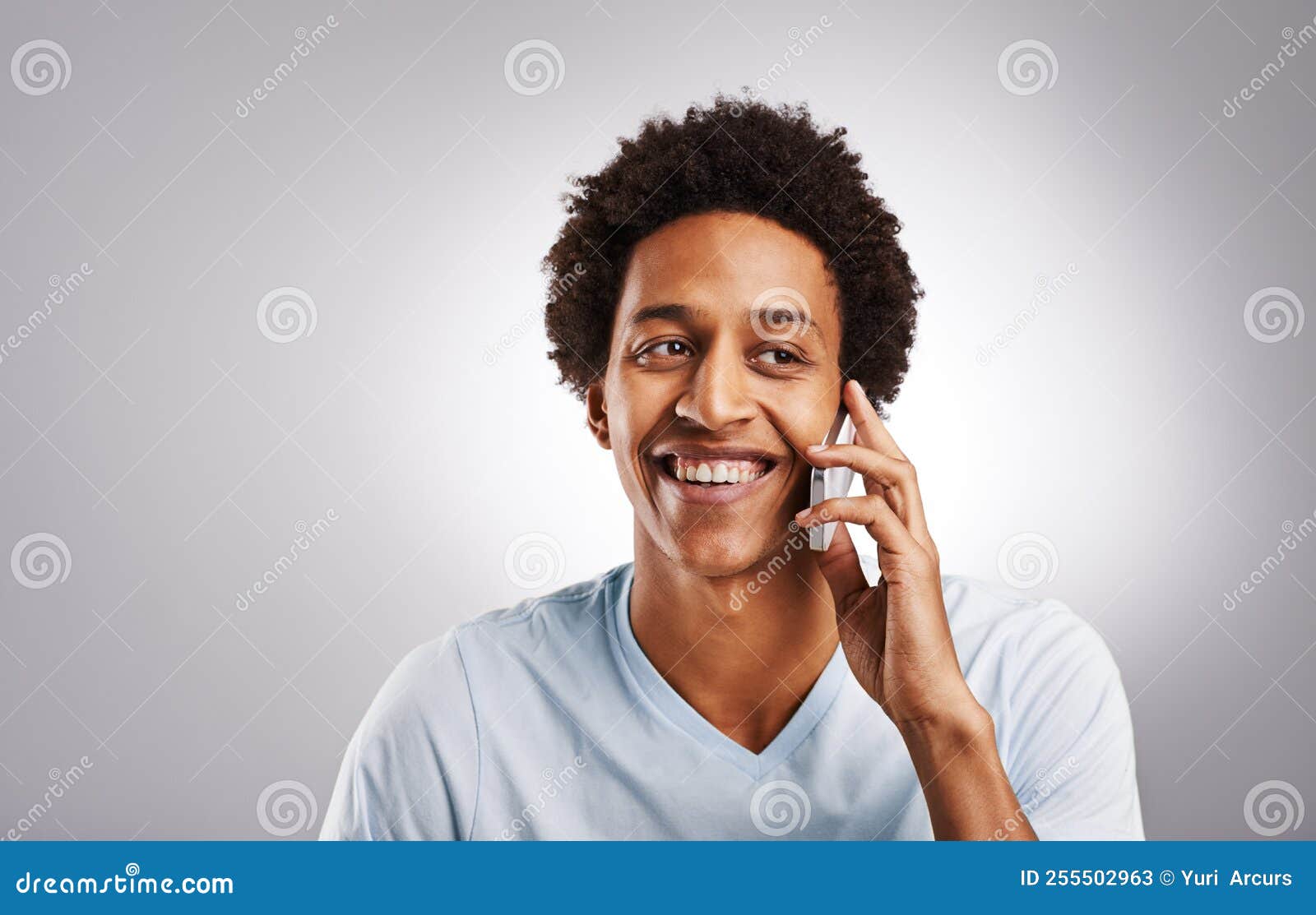 Lets Hang Out. Studio Shot of a Young Man Talking on His Cellphone ...