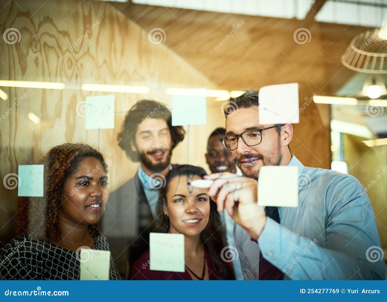 Lets Keep it Simple yet Effective. Coworkers Using Sticky Notes on a ...