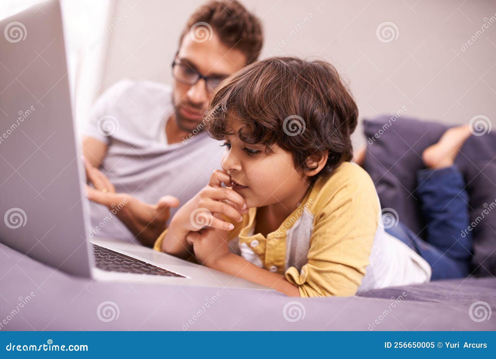 Lets Play the Guessing Game. a Father and Son Using a Laptop while ...
