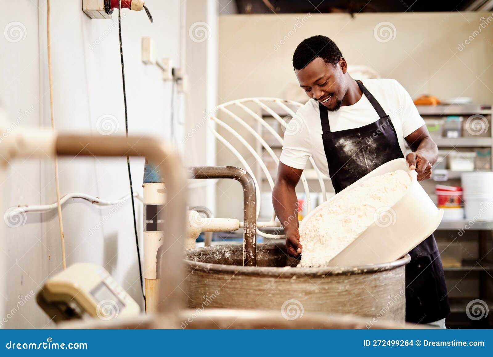 Lets Start the Kneading Process. a Baker Pouring Flour into a Kneading ...