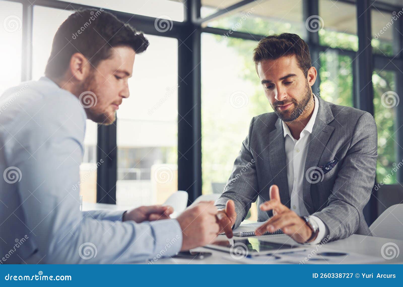 Lets Work on these Points. Two Young Businessmen Working through ...