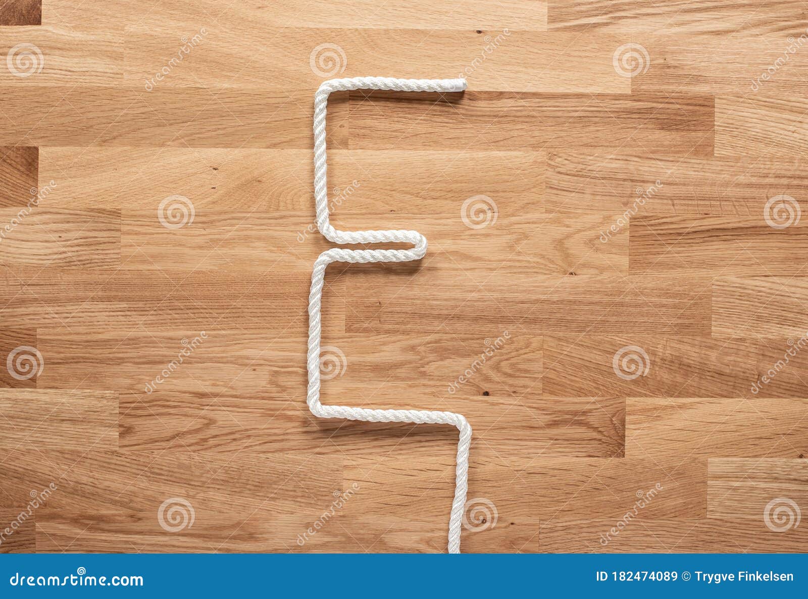 The Letter E Formed with White Rope on a Wooden Table Stock Image ...