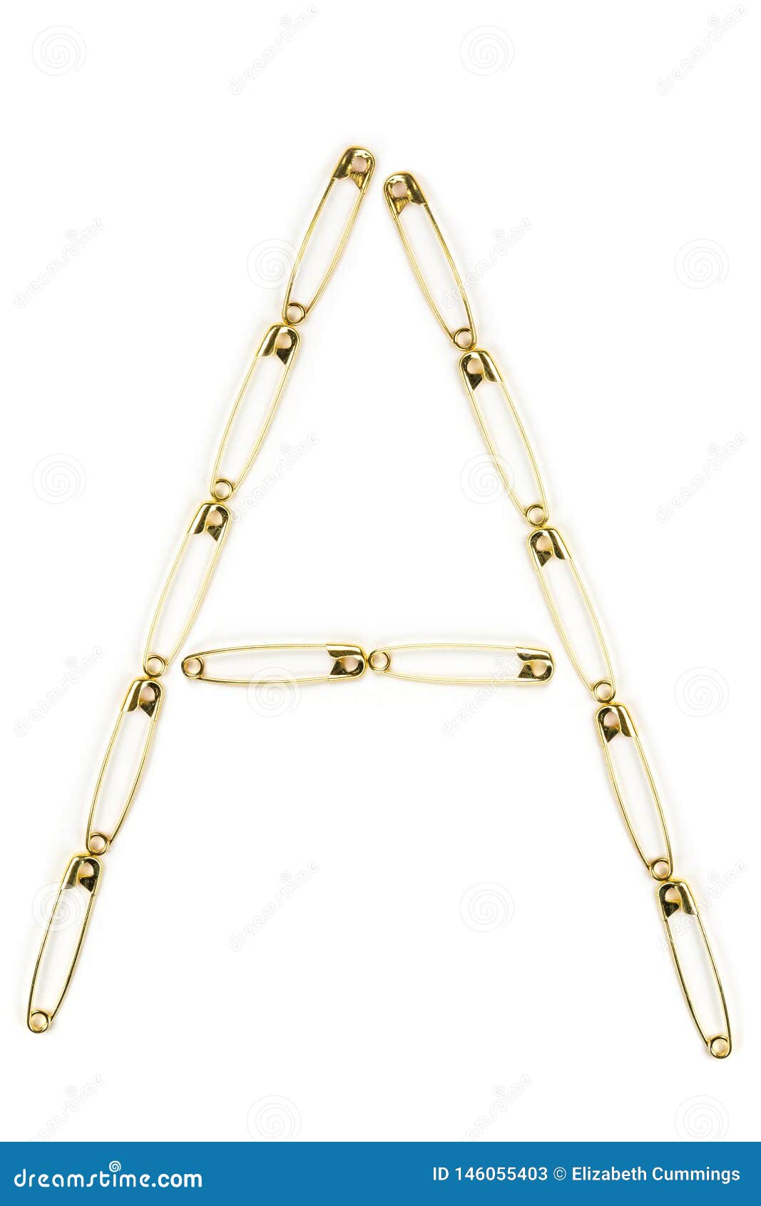 Letter Spelled Out in Gold Colored Safety Pins Stock Image - Image of ...