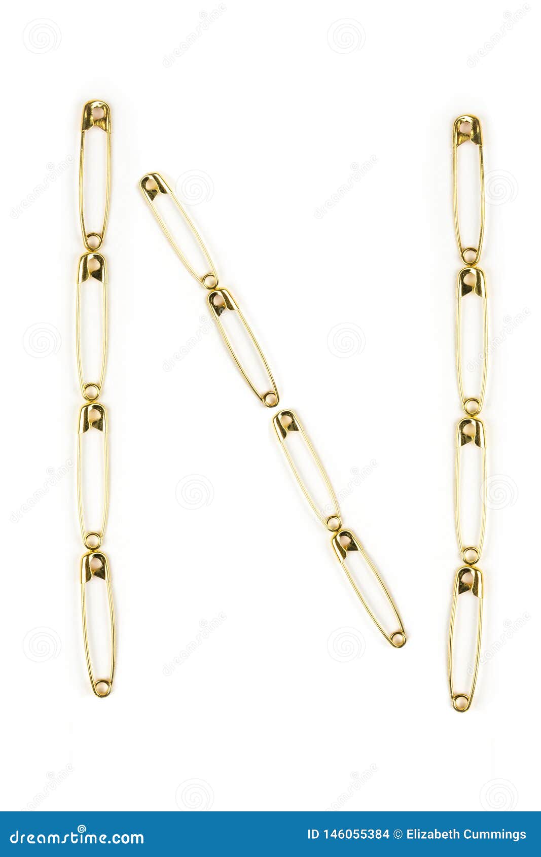 Letter Spelled Out in Gold Colored Safety Pins Stock Photo - Image of ...