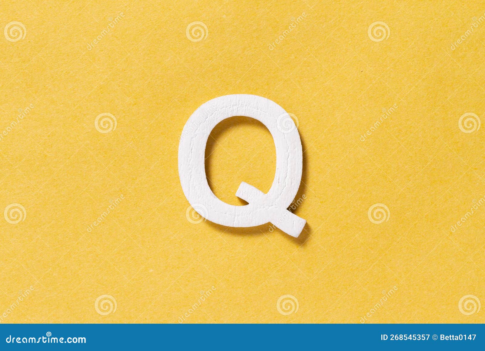 Letter Q of the Alphabet Isolated on Yellow Background, Top View Stock ...