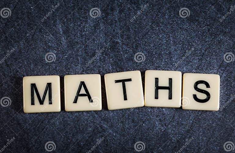 Letter Tiles on Black Slate Background Spelling Maths Stock Photo ...